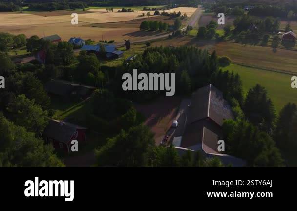 Aerial views capture a traditional Finnish farm nestled among fields ...