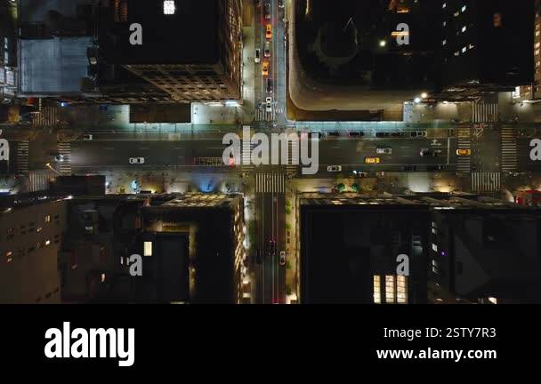 Cars weaving through a lively Manhattan, New York City intersection at ...