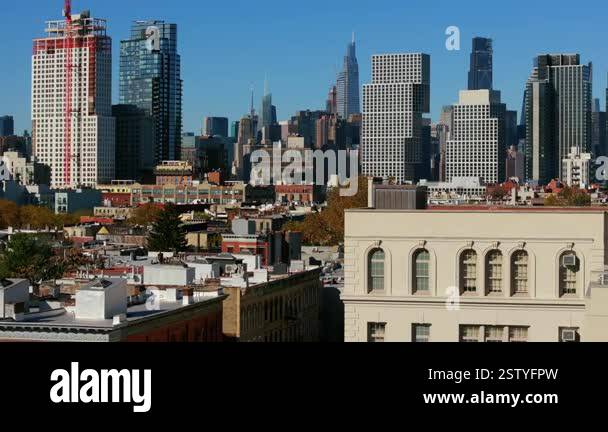 Construction workers restore a rooftop on a Brooklyn building ...