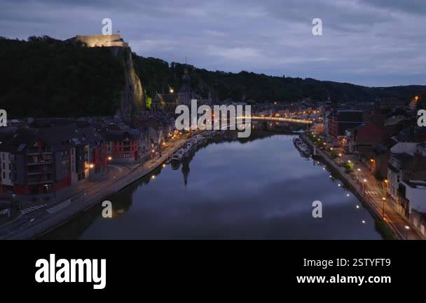 Aerial views capture the glowing cityscape of Dinant, Belgium, gently ...
