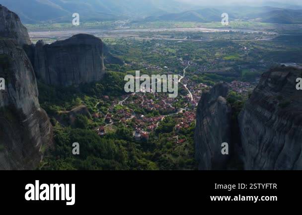 Camera movement captures a panoramic view of kalambaka, a town nestled ...