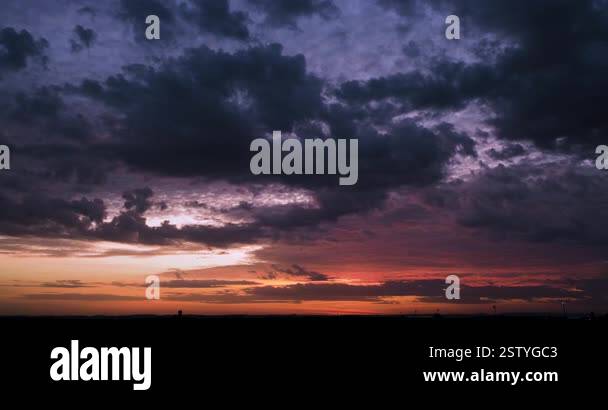 Timelapse of beautiful colorful sunset sky with clouds on the horizon ...