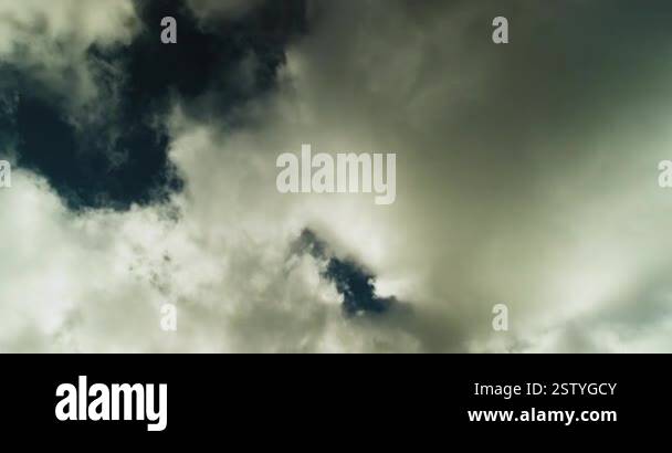 Timelapse of dynamic fluffy white cumulus clouds moving fast low on the ...