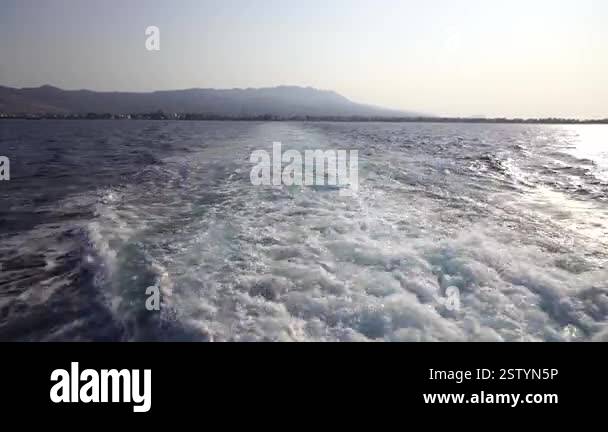 Blue ocean sea water wave with fast yacht boat wake foam of prop wash ...