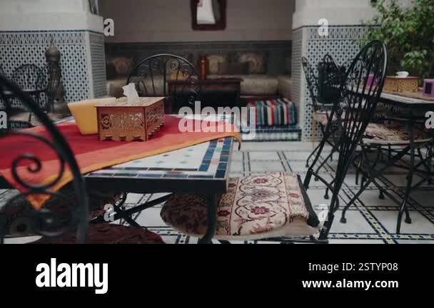 Traditional Moroccan cafe interior with mosaic tiled walls, colorful ...
