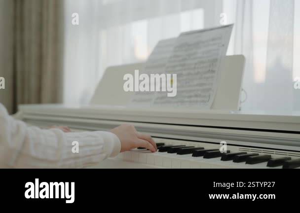 Teenage girl practicing piano at home. Study and learning development concept. Focused young ...