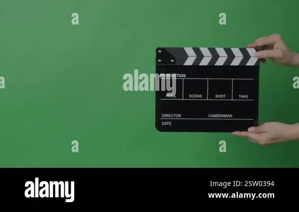 A classic black and white film clapperboard or movie slate being held ...