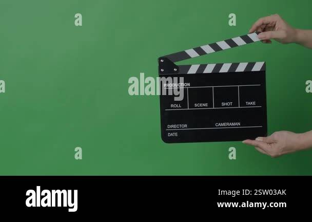A classic black and white film clapperboard or movie slate being held ...
