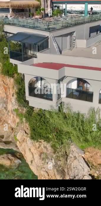 Cliffside infinity pool and beach. Aerial footage of a stylish and ...