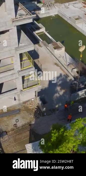 Foundation pouring and crane work ongoing. Aerial footage of a dynamic and professional building ...