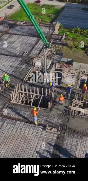 Crane and wall construction ongoing. Aerial footage of a vibrant and professional building ...