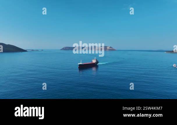 See the impressive cargo ship dropping anchor in the deep blue sea as ...