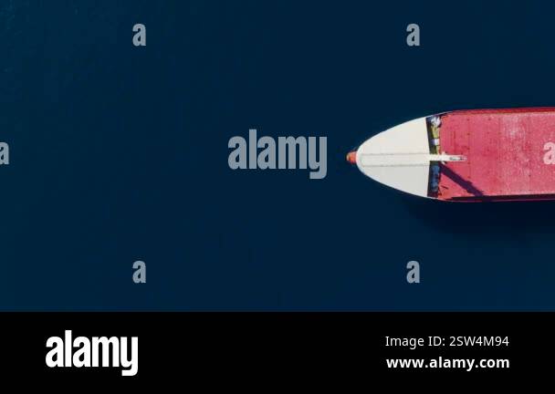 See the big cargo ship dropping anchor in the deep blue sea as the sky ...