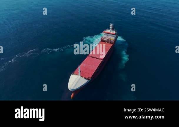 Watch the impressive cargo ship drop anchor in the deep blue waters of ...