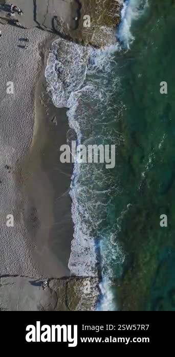 Aerial beach texture. Vertical footage of a natural ocean shoreline ...