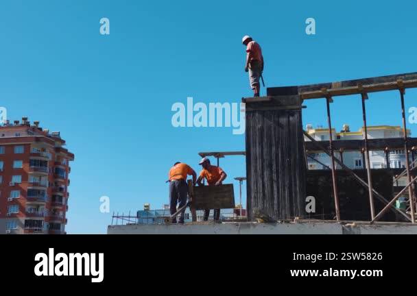 The construction site is alive with workers expertly handling tasks and ...