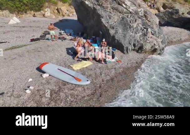 A stunning beach with crystal-clear waters where people swim, relax ...