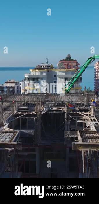 Aerial frame assembly process. Vertical footage of a modern house under ...