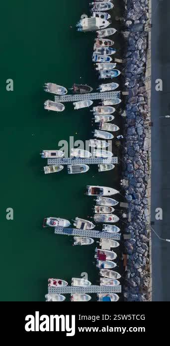 Aerial cruise boat docking. Vertical footage of a vibrant maritime ...