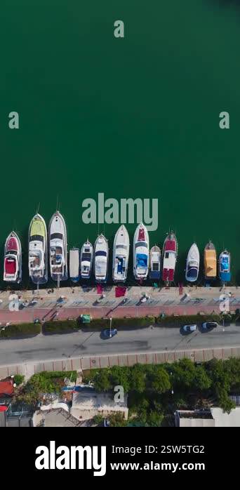 Aerial view of a yacht-filled dock. Vertical footage of a peaceful ...