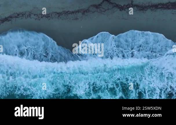 The rough sea crashes into the cliffs at dawn, showing off the dramatic ...