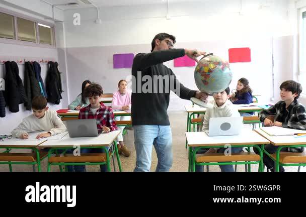 Geography instructor presenting educational world globe to attentive ...