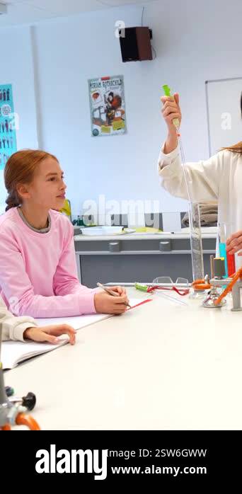 Experienced chemistry teacher conducting precise titration experiment ...