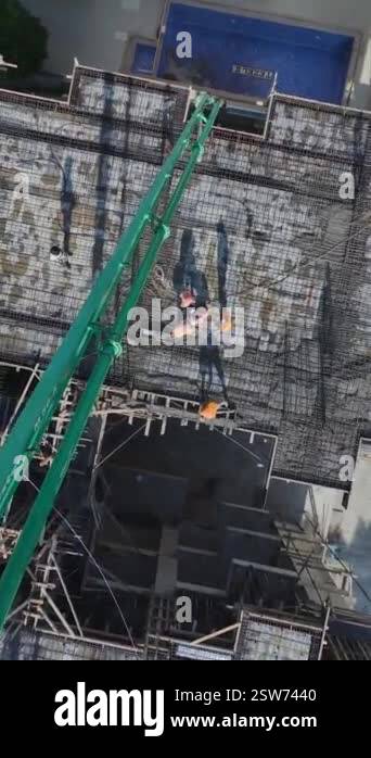 Vertical Video: Concrete Pouring and Heavy Machinery in Use at a ...
