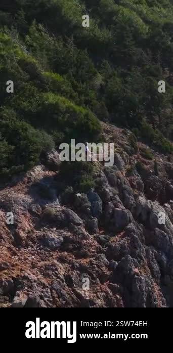 Rocky slope and greenery. Aerial footage of a peaceful and natural ...