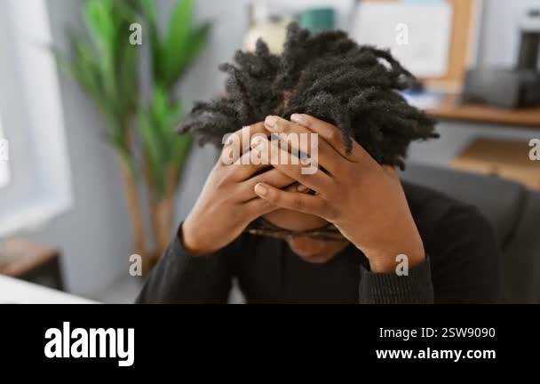 Young stressed african american woman with dreadlocks in office ...