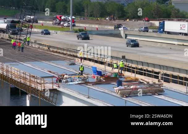 Hardhat workers on American highway bridge road under construction ...