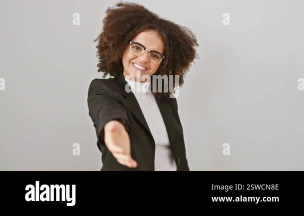 Cheerful hispanic woman with curly hair standing with successful ...