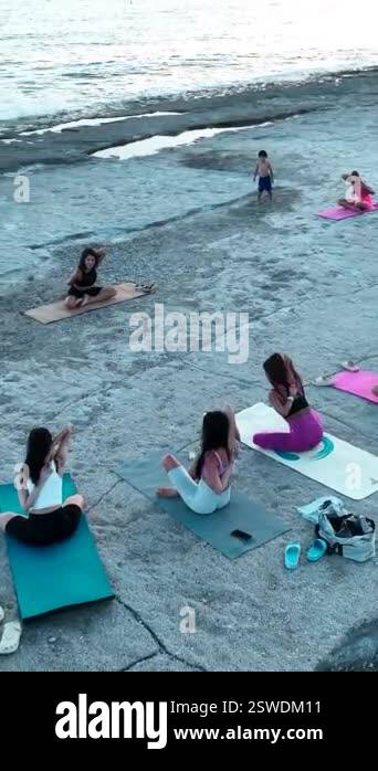 Vertical Video: Yoga poses at sunset under a vibrant Mediterranean sky ...
