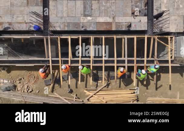 A team of construction workers builds a new high-rise apartment complex ...