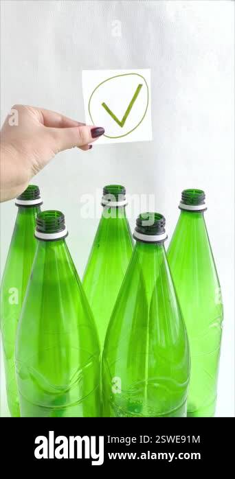 Plastic bottles on a white background, a hand holding a green check ...