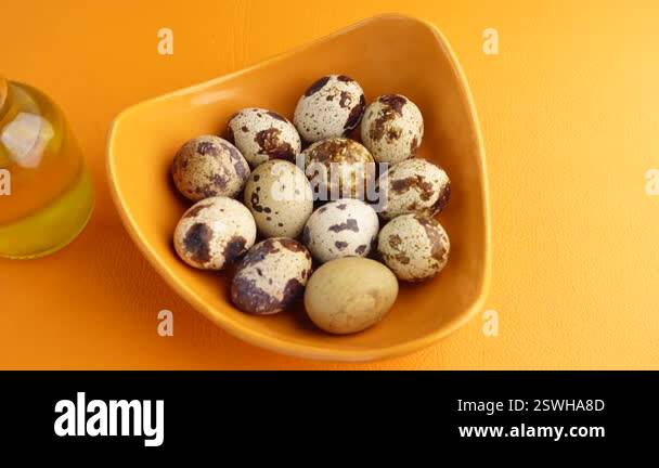 A collection of quail eggs in various colors arranged in a bowl Stock ...