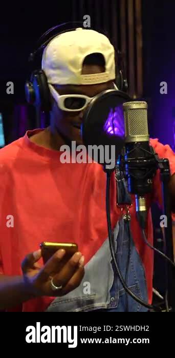 Young african american male singer capturing professional vocals ...