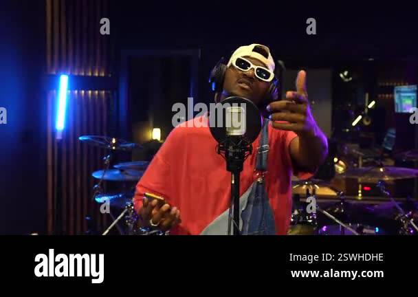 Talented musician singing and performing in a professional recording ...
