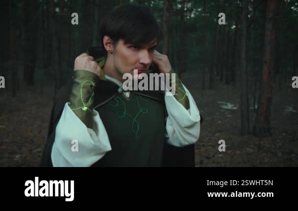 Portrait fantasy male elf prince. man thief puts hood on head hides ...