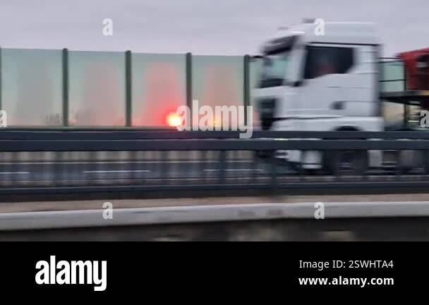 soundproof wall of blue glass on a highway bridge embedded in metal ...