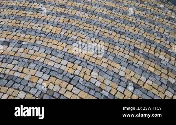 stone paving in the square folded into circles with a larger tile in ...
