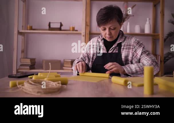 craftswoman making natural handmade candle on table in workshop. Copy ...
