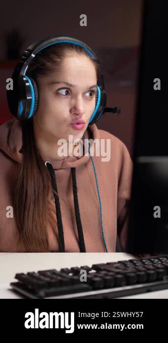 Nervous stressed Caucasian female gamer wearing headphones play video ...