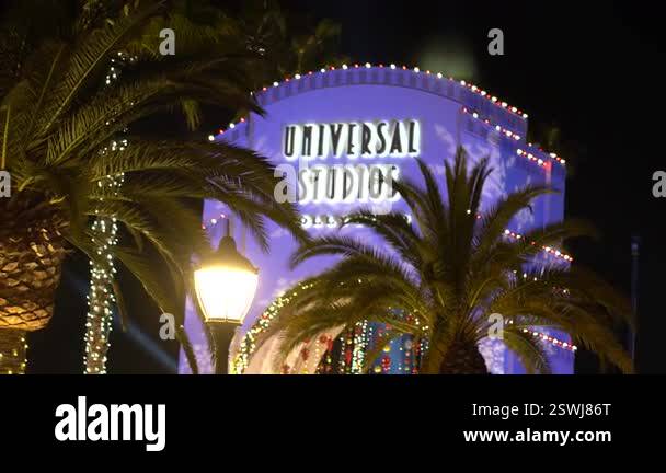 A cinematic nighttime view of the illuminated entrance to Universal ...