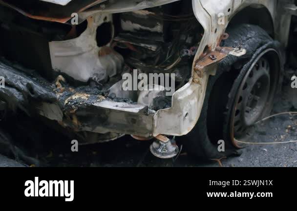 Close-up of a severely damaged and burned car. Shows the aftermath of a ...