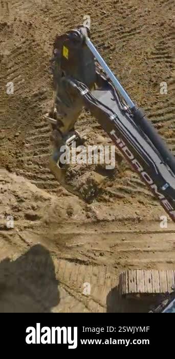 Machines and workers ensure the construction project starts on a solid ...