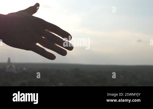 Friendly handshake of two unrecognizable men on cityscape background ...