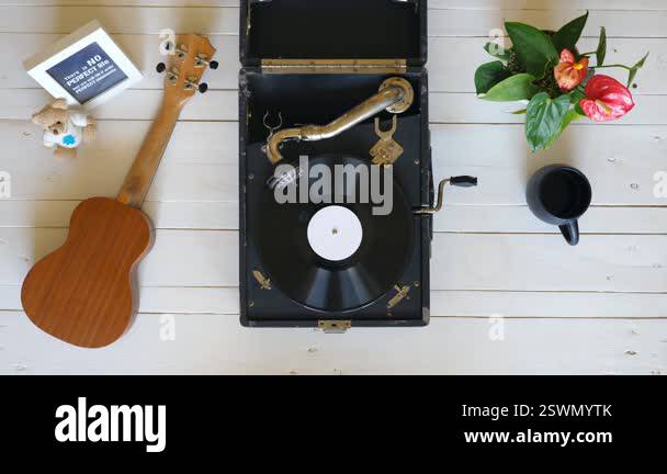 Top view on old playing gramophone at white wooden table. Vinyl record ...