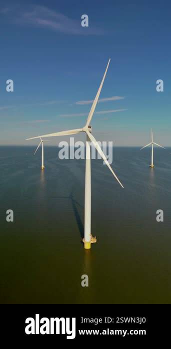 Witness the stunning landscape of wind turbines standing tall above ...