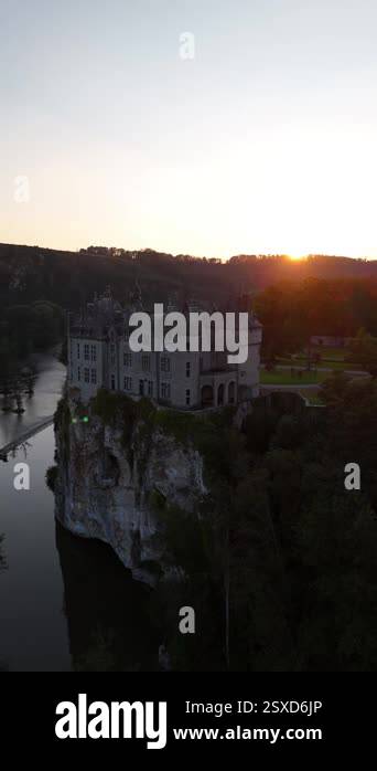 Nestled on a cliffside, Walzin Castle stands majestically by the river ...